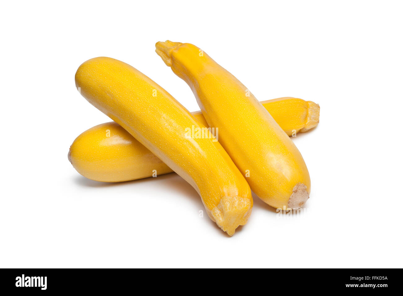 Fresh yellow courgettes on white background Stock Photo - Alamy