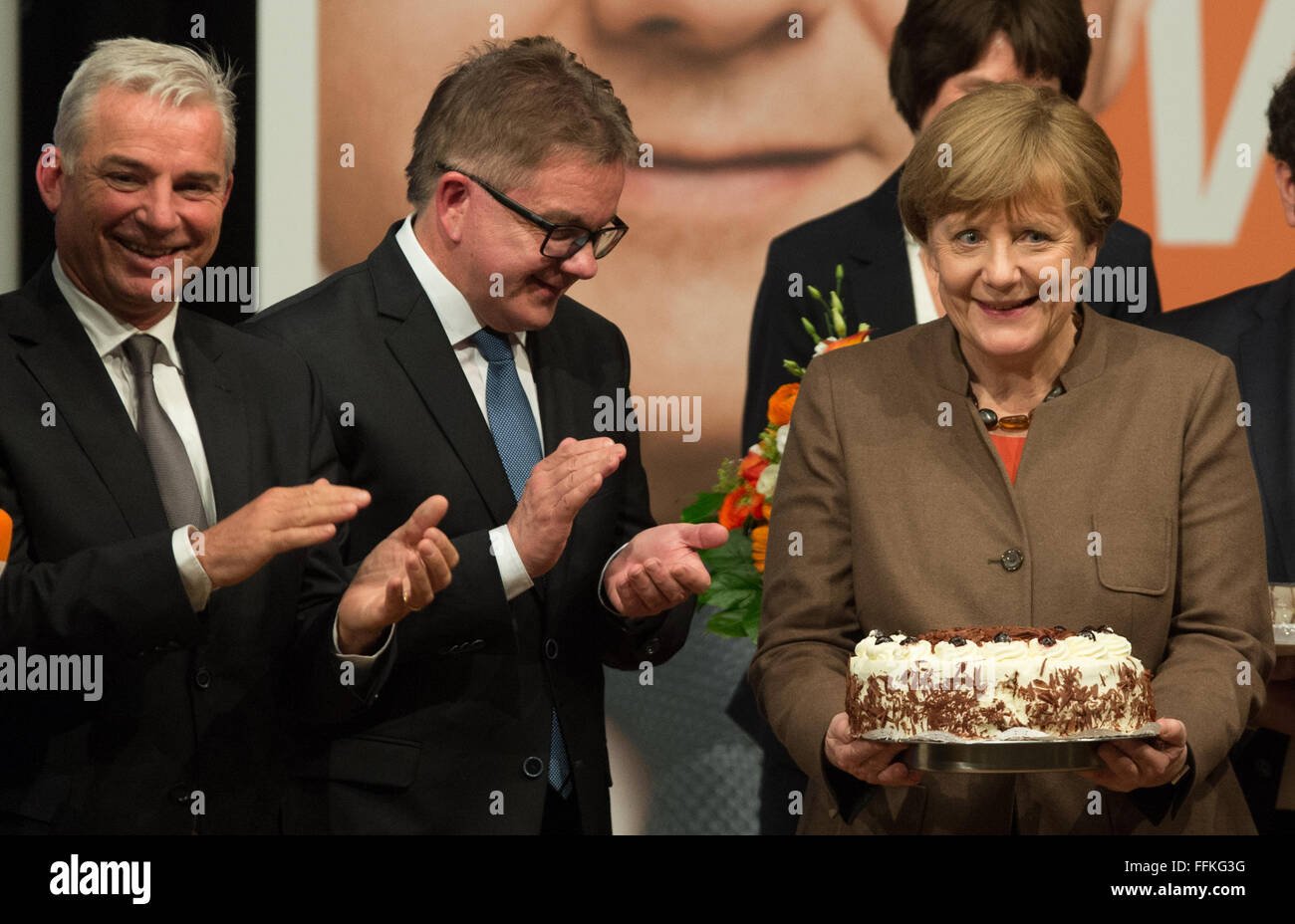 German Chancellor Angela Merkel (CDU) holding a Schwarzwaelder ...