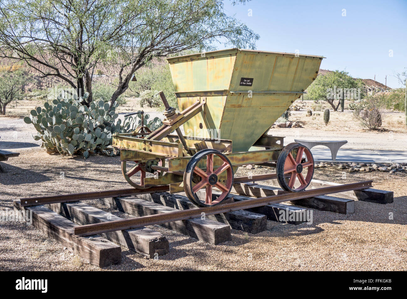 delightful rust streaked faded green old ore cart with red wheel spokes ...