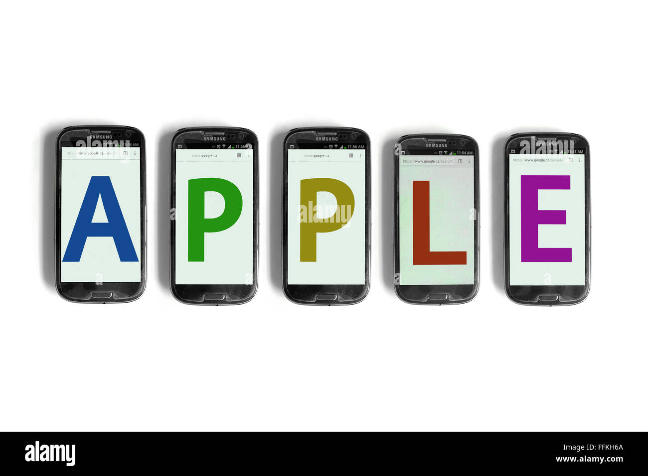 Apple written on smartphone screens photographed against a white ...