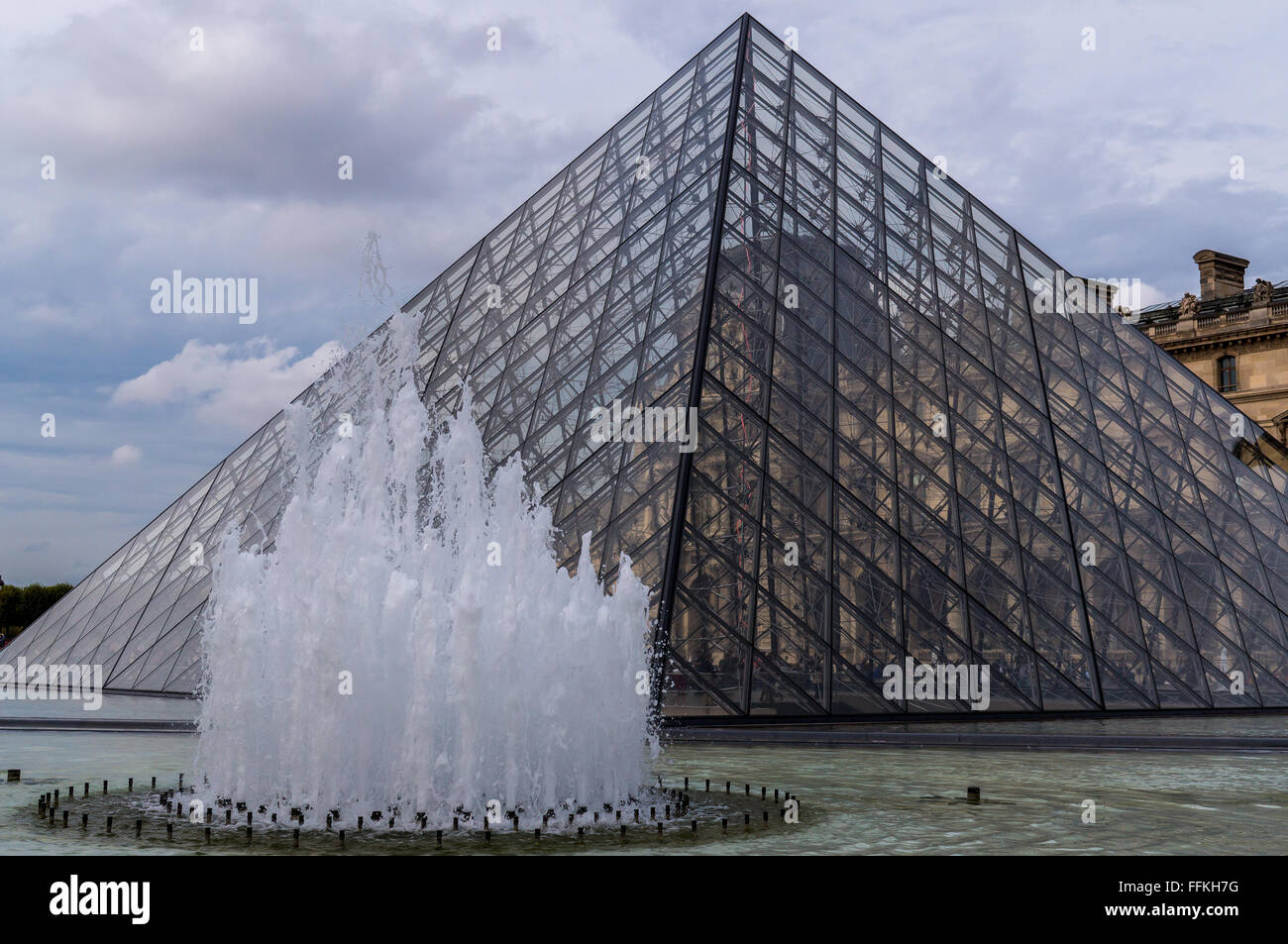 The Louvre museum pyramid and fountain Stock Photo - Alamy