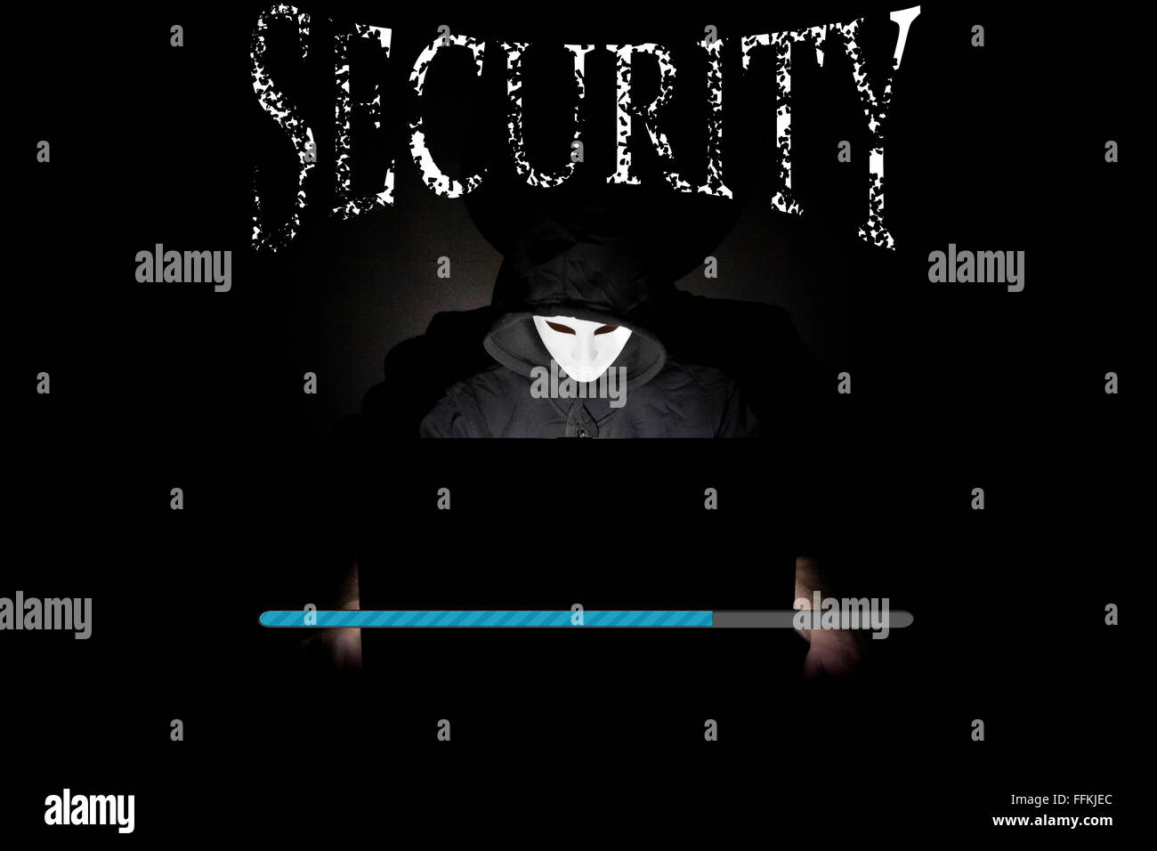 A masked man at a laptop symbolising the dangers of the Internet Stock ...