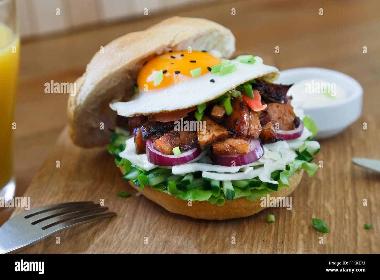 Japanese chicken burger with onions, letucce and egg Stock Photo - Alamy