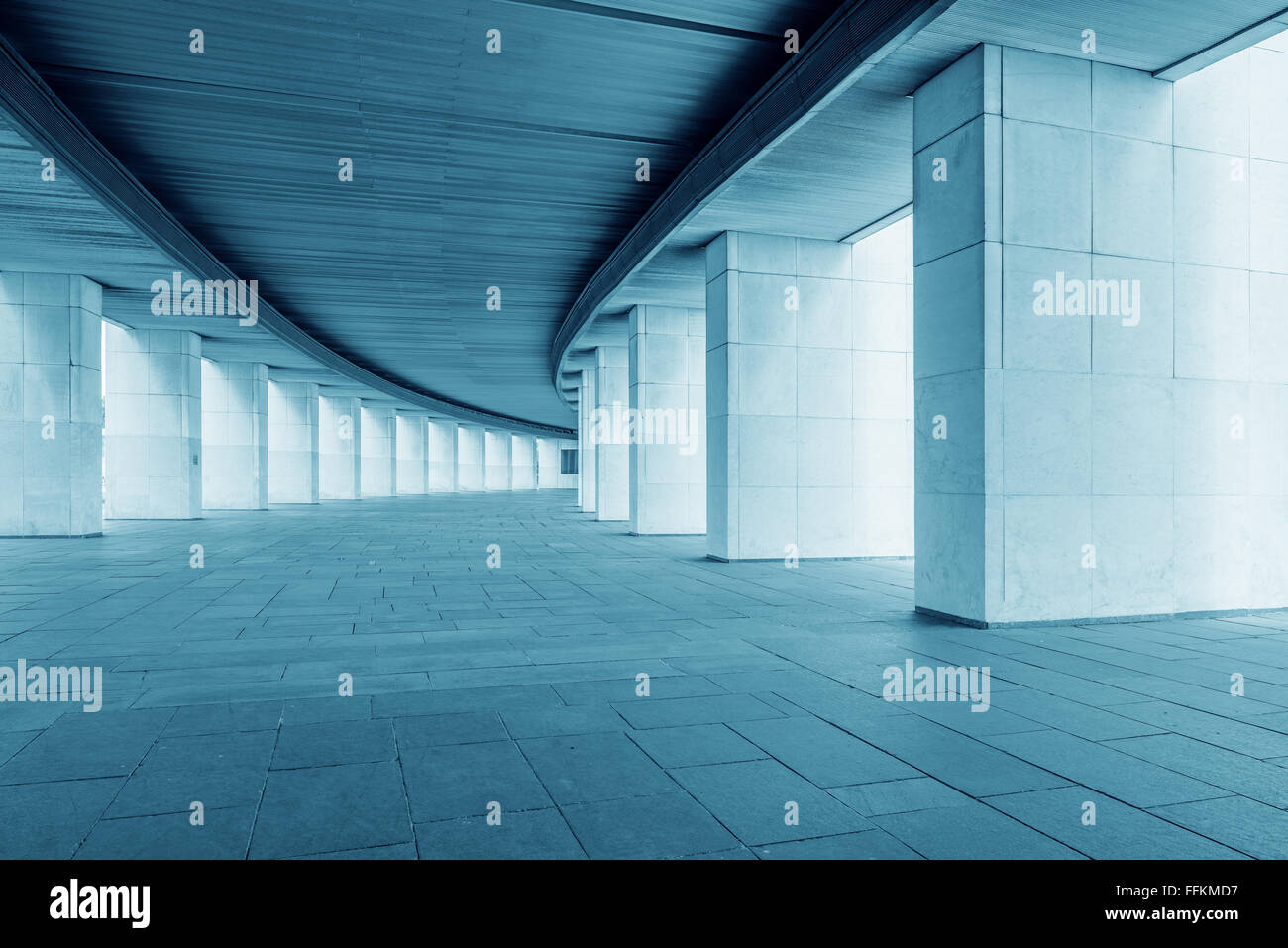 Long wide corridor of the building with columns at summer day time ...