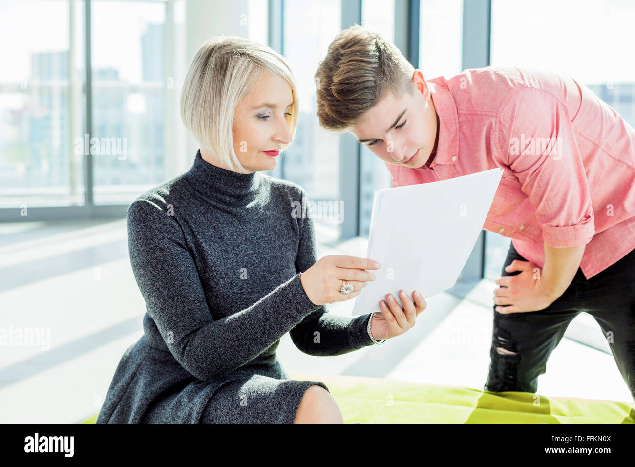 Female architect with trainee in modern office Stock Photo - Alamy