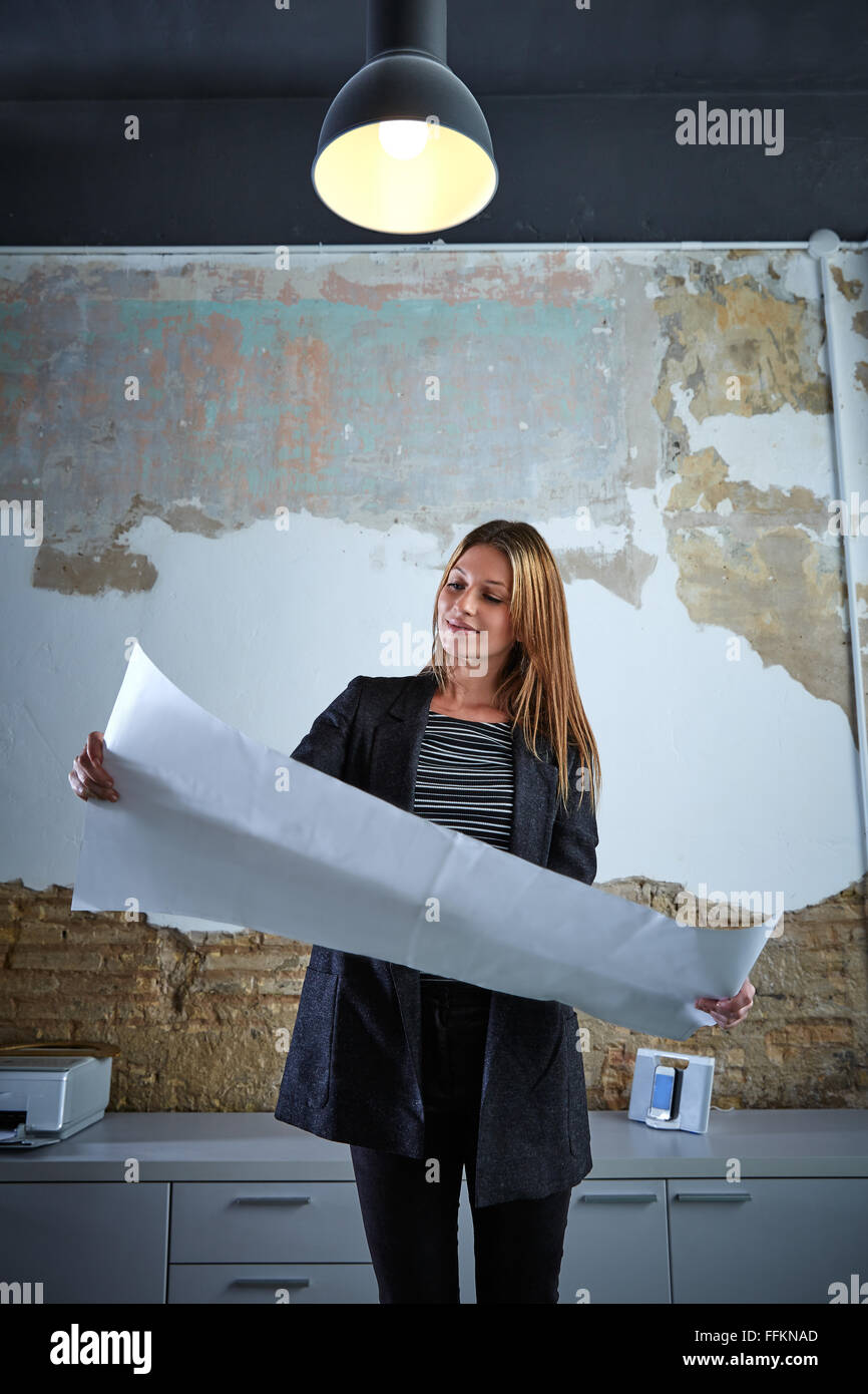 Architect woman working holding plan paper at office Stock Photo - Alamy