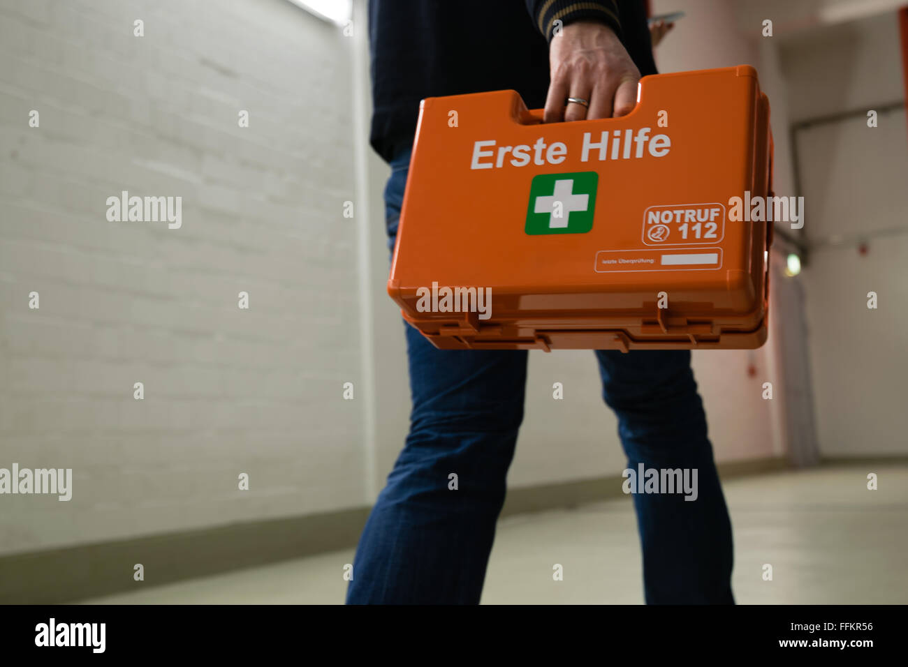 First aid after an accident at work. First responder with first aid kit ...