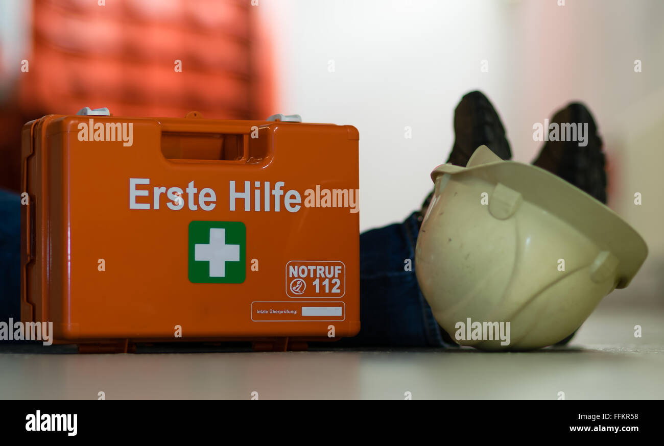 First aid after an accident at work. First aid kit and helmet near ...