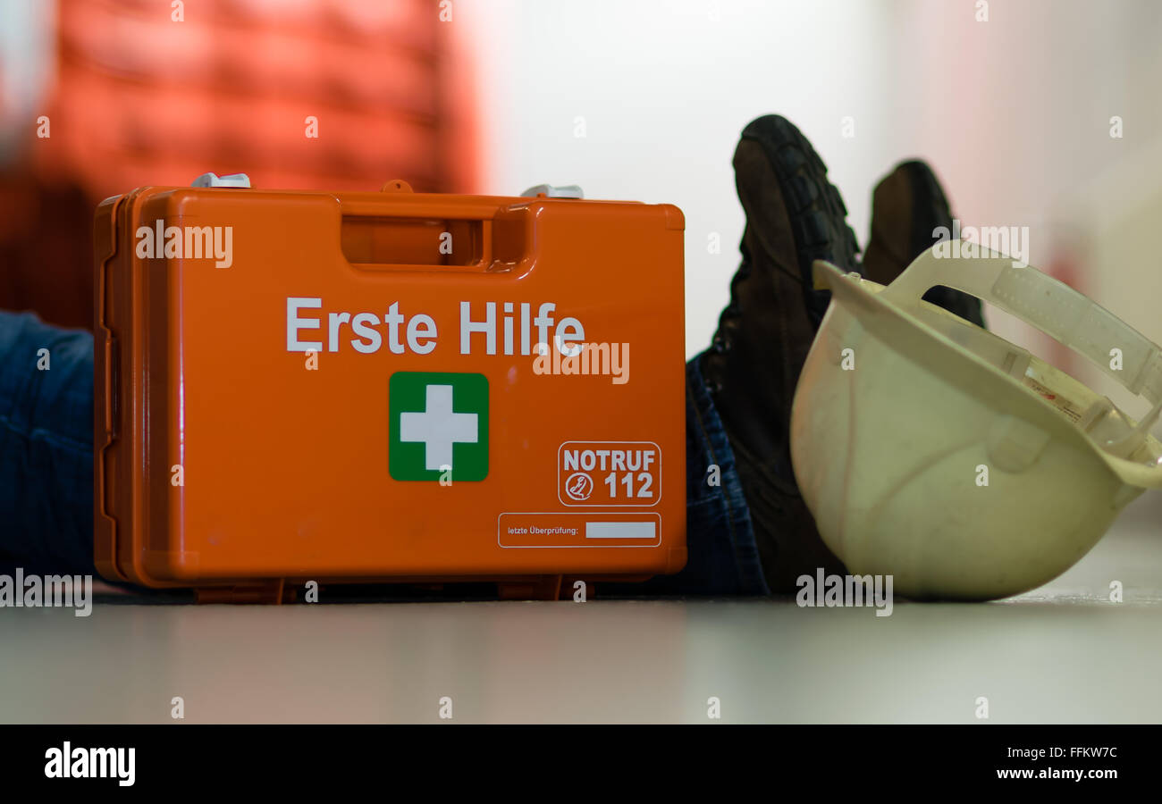 First aid after an accident at work. First aid kit and helmet near ...