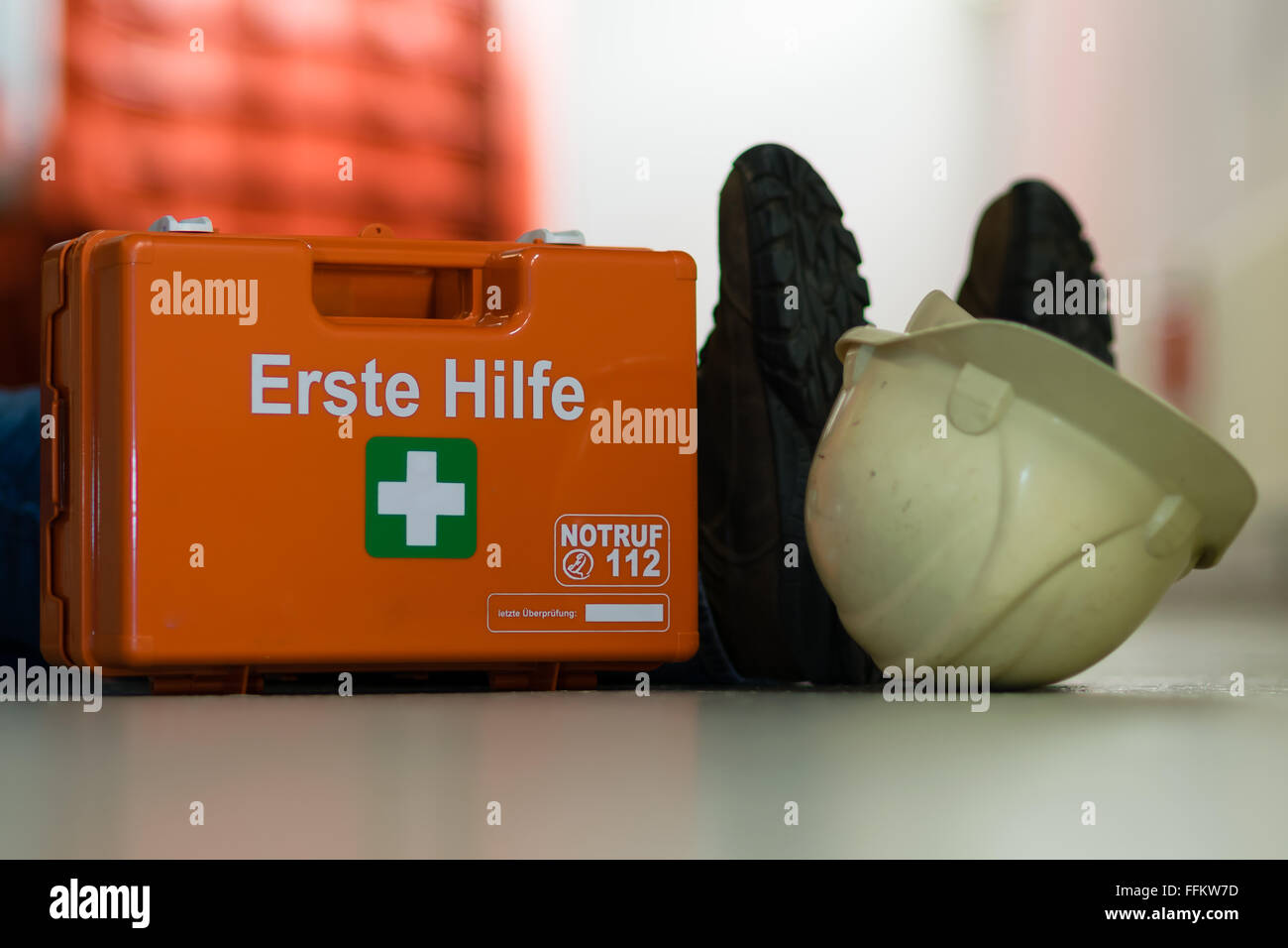 First aid after an accident at work. First aid kit and helmet near ...