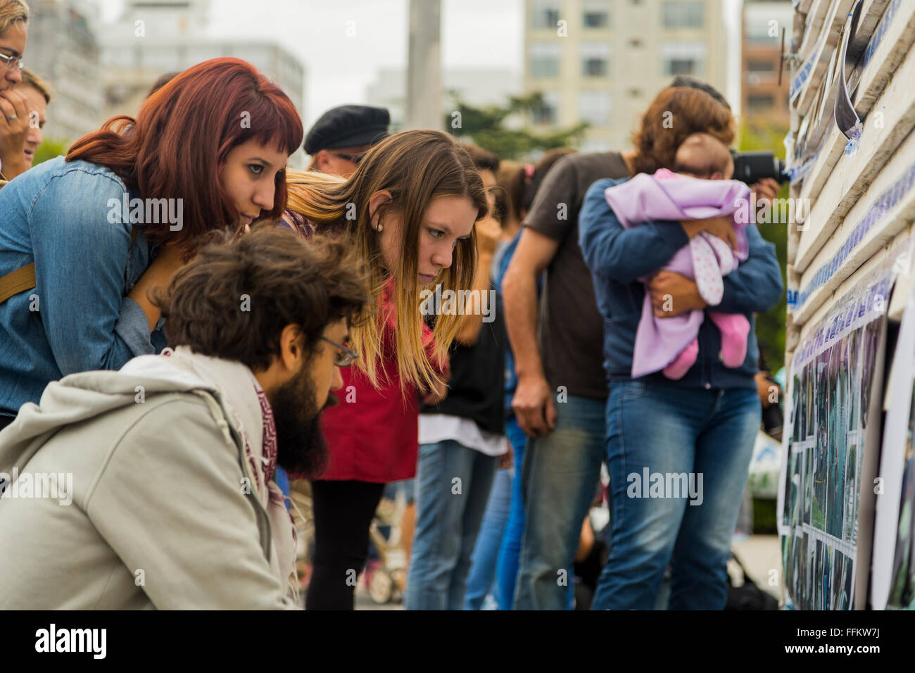 Group of young people watching pictures on a wall Stock Photo - Alamy