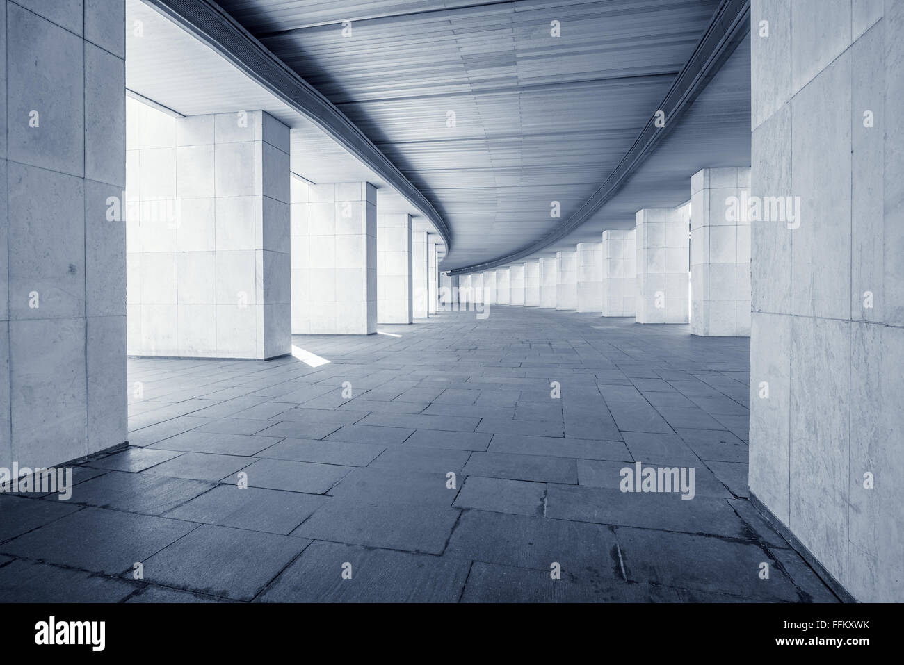 Long wide corridor of the building with columns at summer day time ...