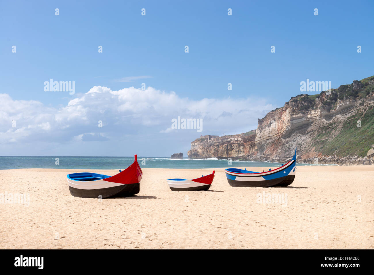 Main beach in Nazare with Traditional colorful boat on the sand ...