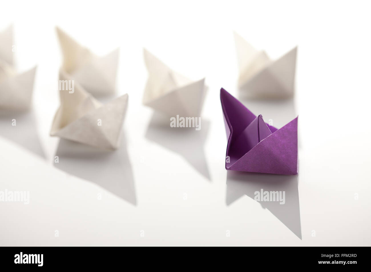 Leadership concept using blue paper ship Stock Photo - Alamy