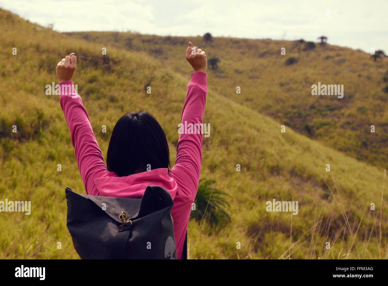 Happy woman standing with hands up. Future / freedom / hope / success ...