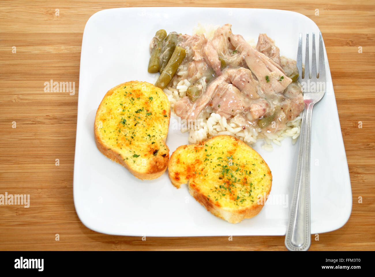 Chicken and Rice Dinner with Garlic Bread Stock Photo - Alamy