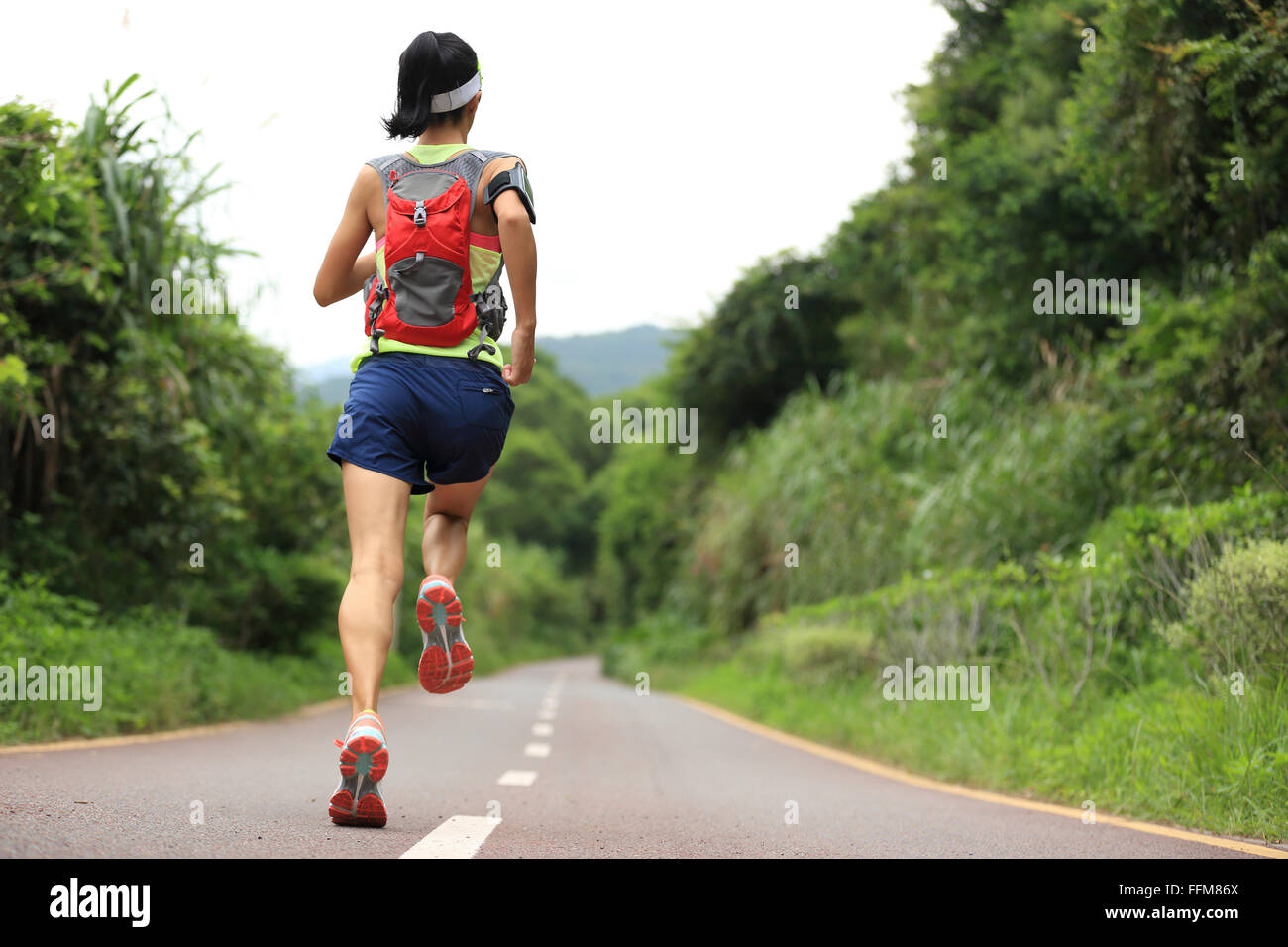 young fitness woman trail runner running on trail Stock Photo - Alamy