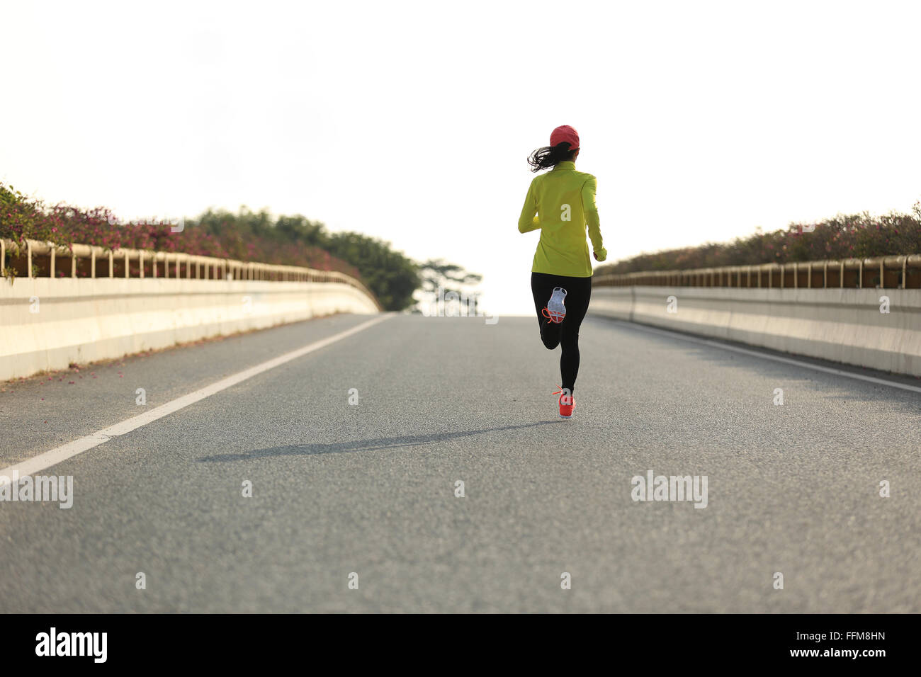 young sports woman runner running on city road Stock Photo - Alamy