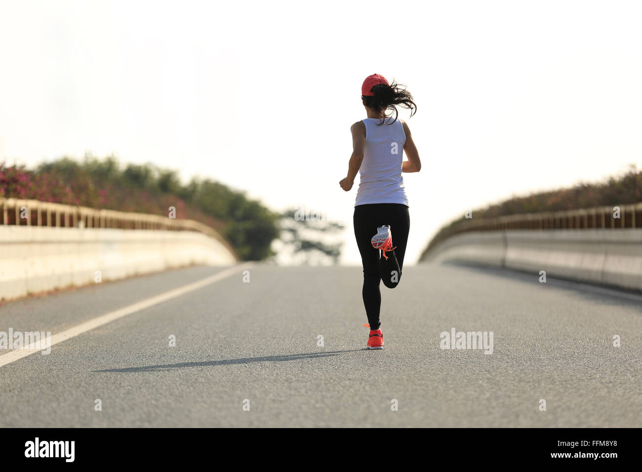 young sports woman runner running on city road Stock Photo - Alamy