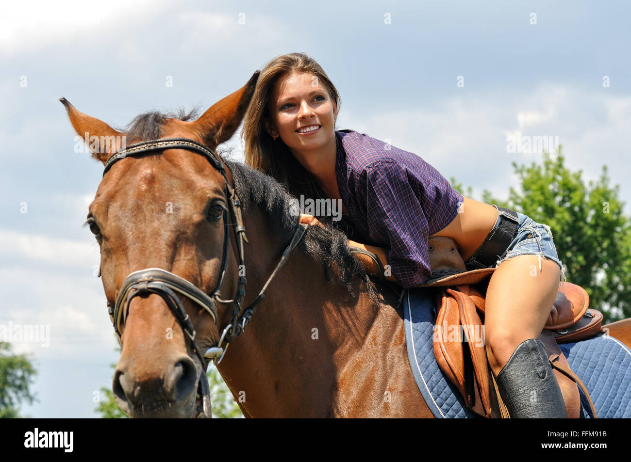 young attractive woman horseback riding Stock Photo - Alamy