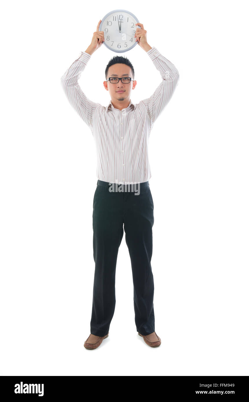 asian business man holding a clock concept photo Stock Photo - Alamy