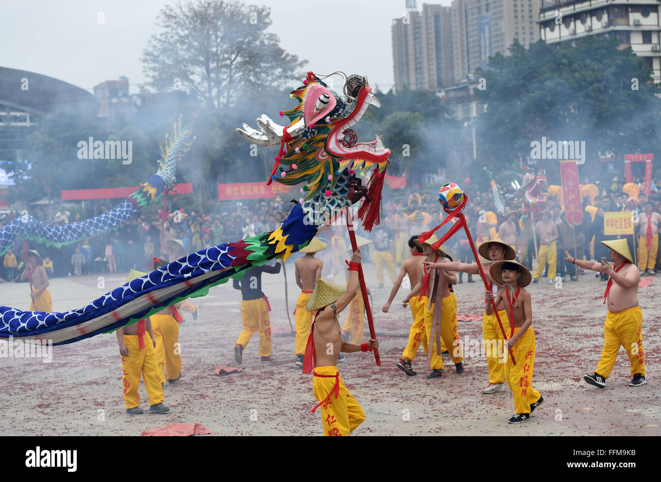 Binyang. 16th Feb, 2016. People perform dragon dance in the flames of ...