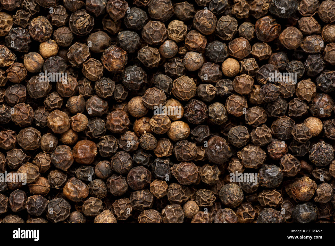Black pepper grains as background close up Stock Photo - Alamy