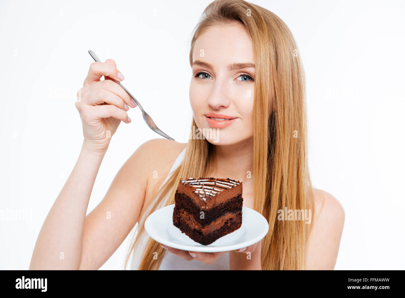 Smiling beautiful young woman eating chocolate cake over white ...