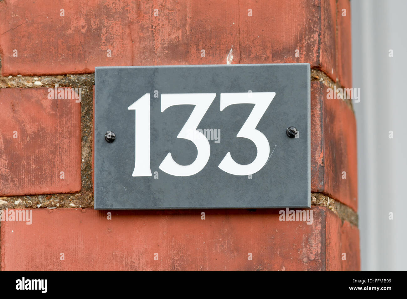 House number 133 sign on wall Stock Photo - Alamy