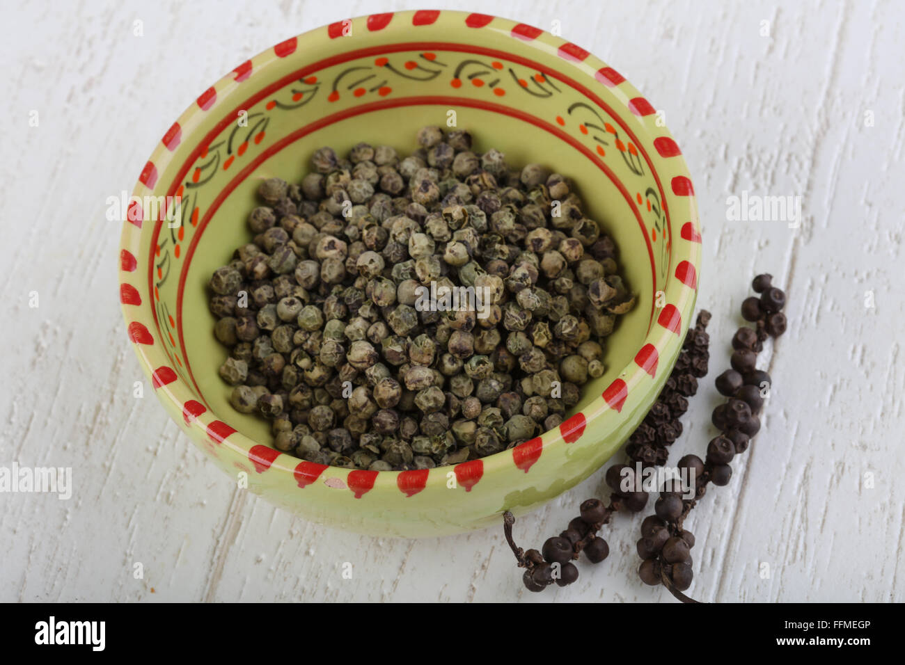 Dry Green pepper corn on the wood background Stock Photo - Alamy