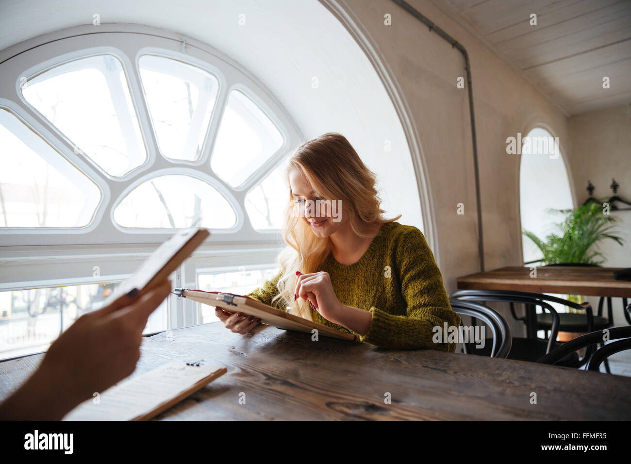Woman reading menu in restaurant hi-res stock photography and images ...