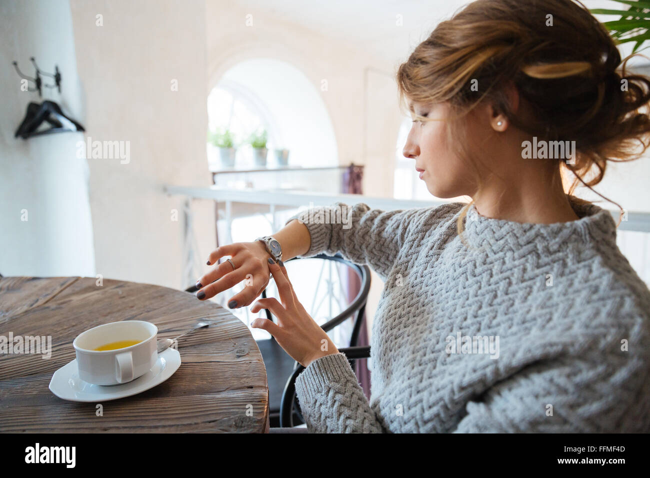 Woman cup clock hi-res stock photography and images - Alamy
