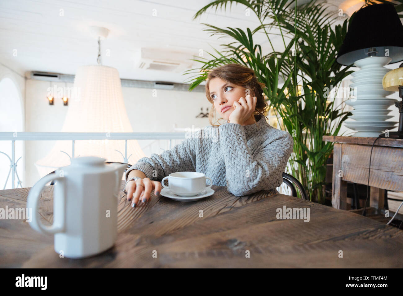 Young woman waiting somebody in cafe Stock Photo - Alamy