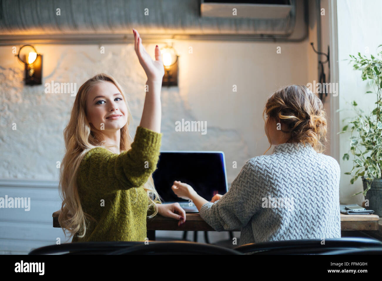 Restaurant customer calling waiter hi-res stock photography and images ...