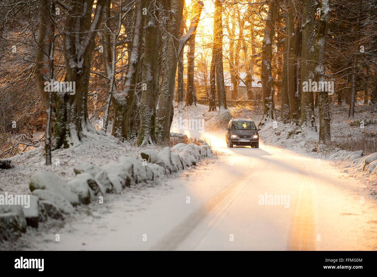Car driving in the snow in Dunecht Estate in Aberdeenshire, Scotland ...