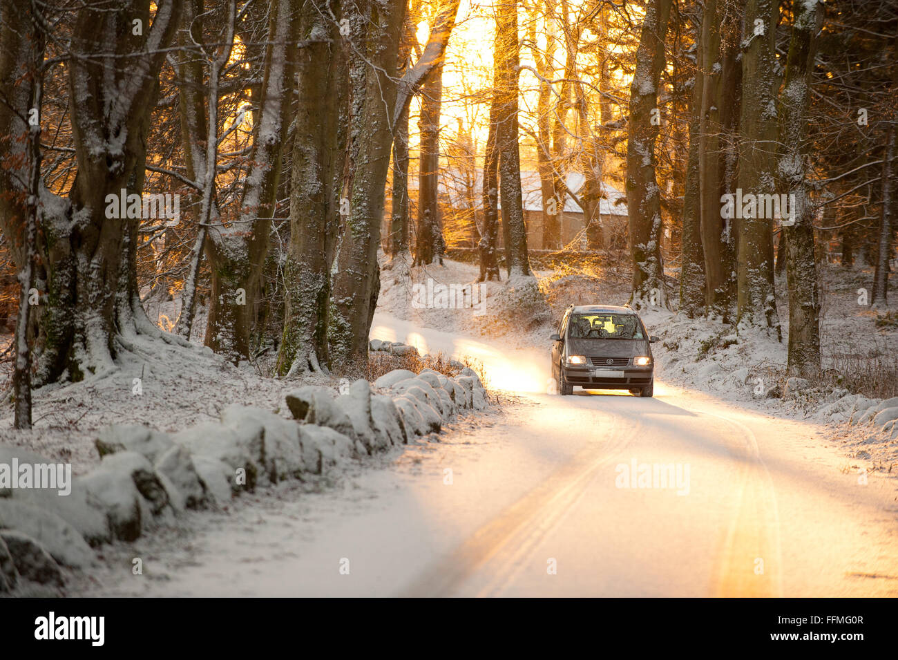 Car driving in the snow in Dunecht Estate in Aberdeenshire, Scotland ...
