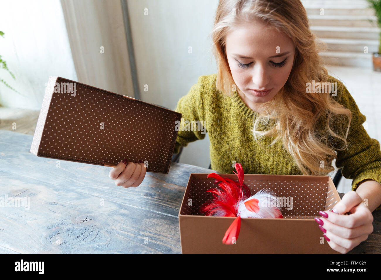 Beautiful woman opening gift box Stock Photo - Alamy