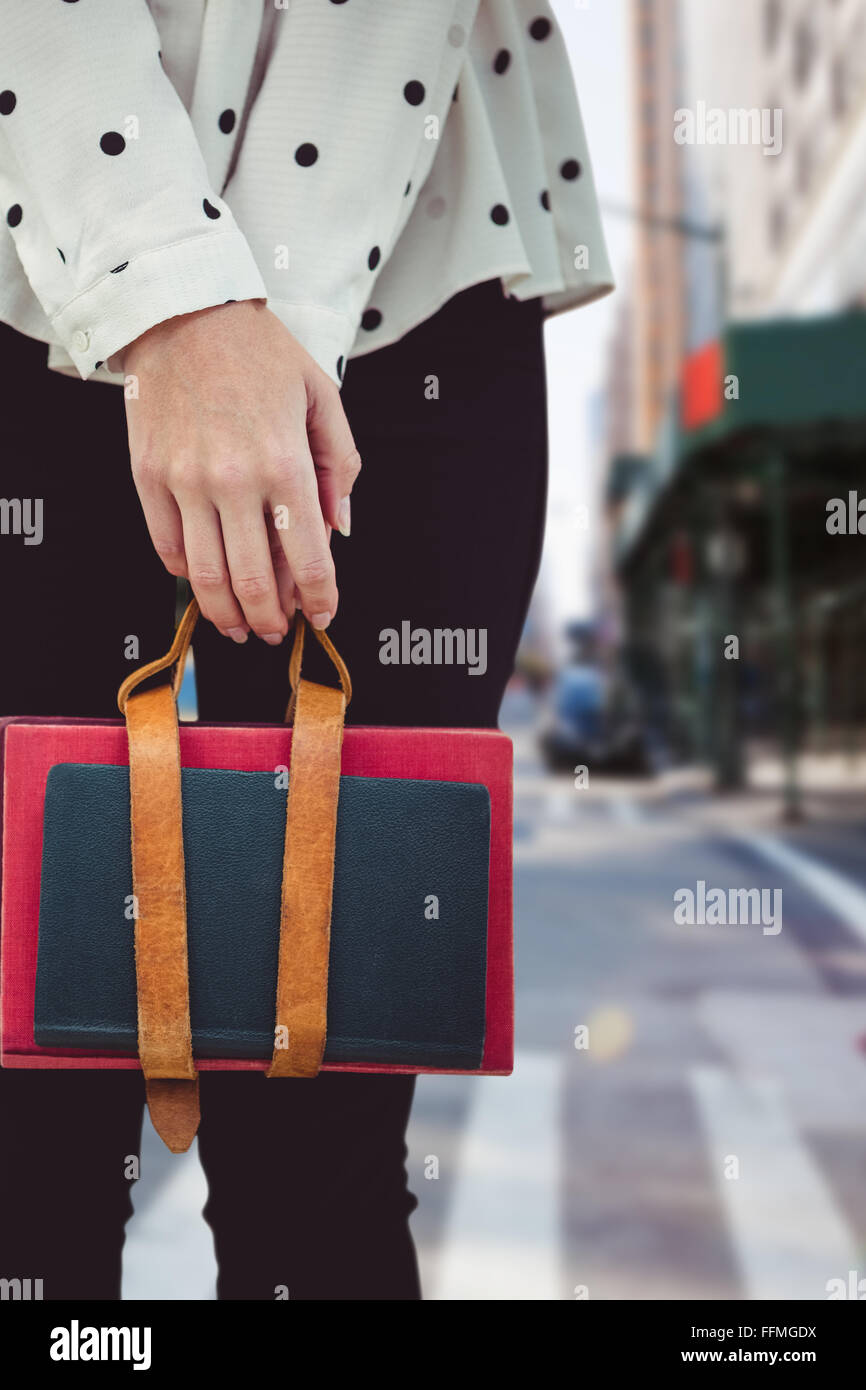 Composite image of cropped image of woman holding book belt Stock Photo ...