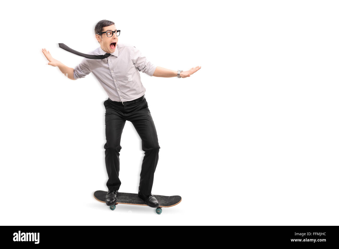 Full length portrait of a young businessman riding a skateboard fast ...