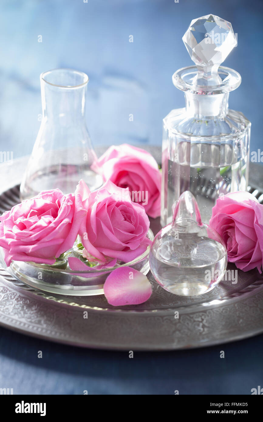 alchemy and aromatherapy with rose flowers and chemical flasks Stock ...