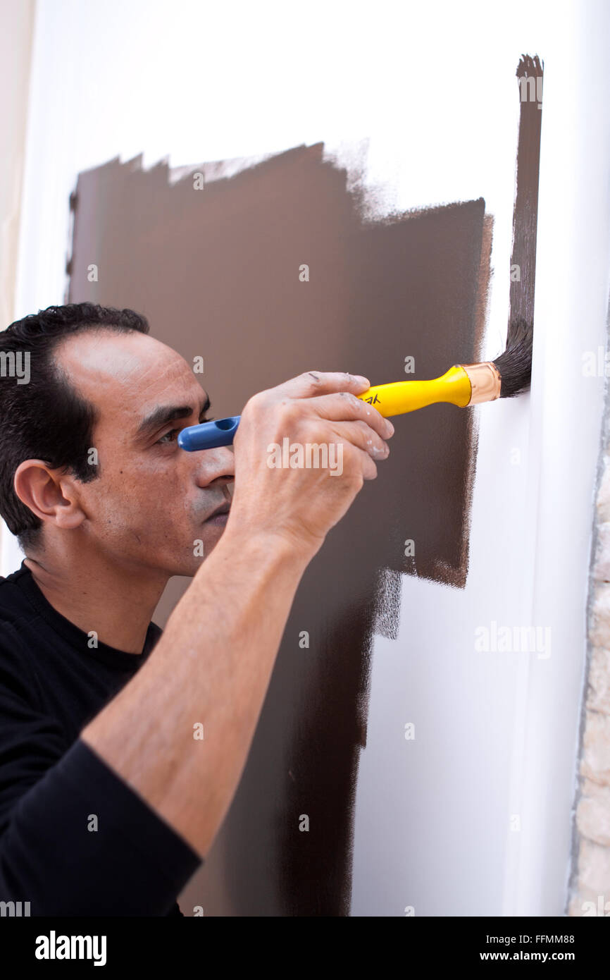 Man painting new house Stock Photo - Alamy