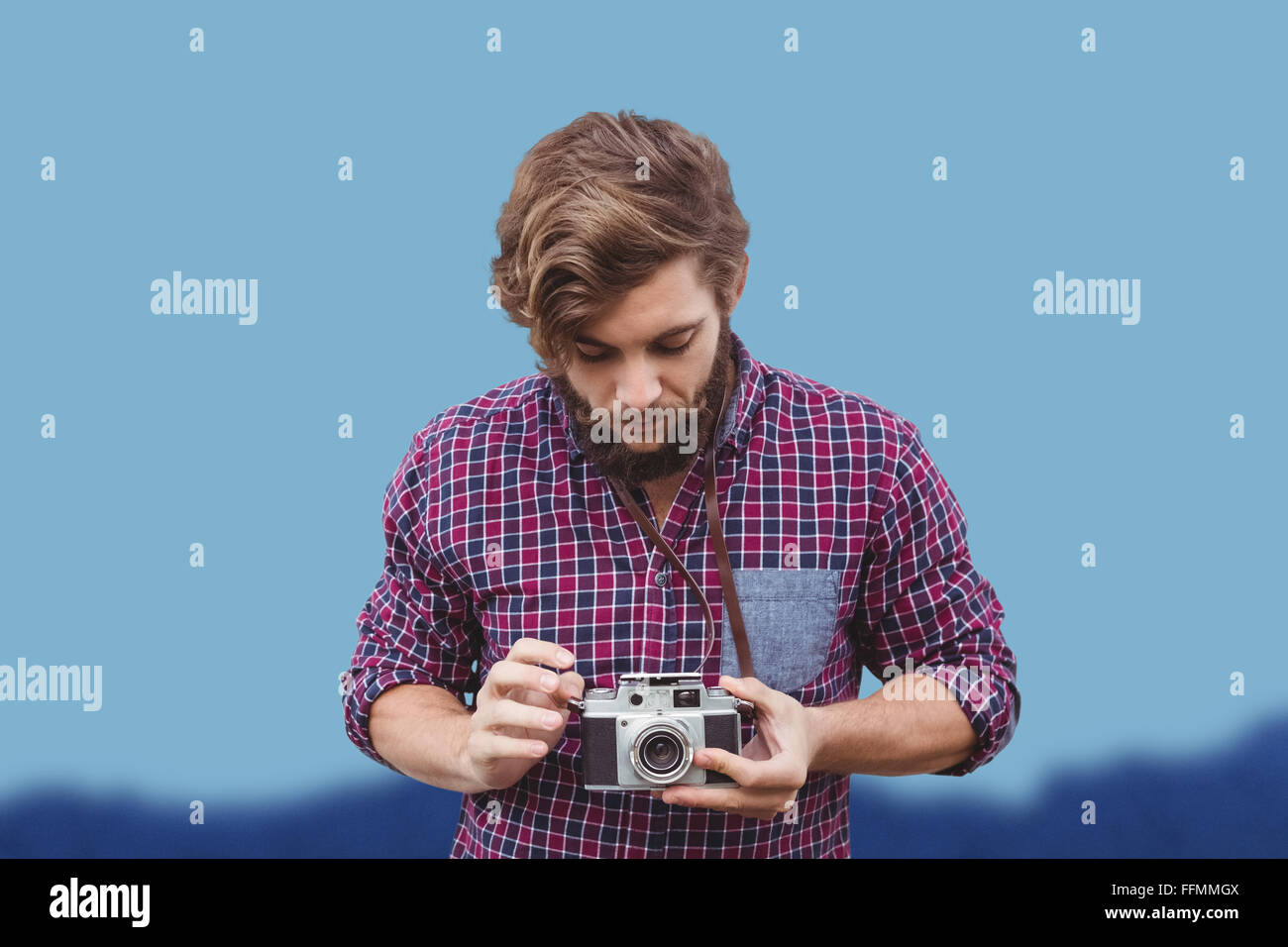 Composite image of hipster using camera Stock Photo - Alamy