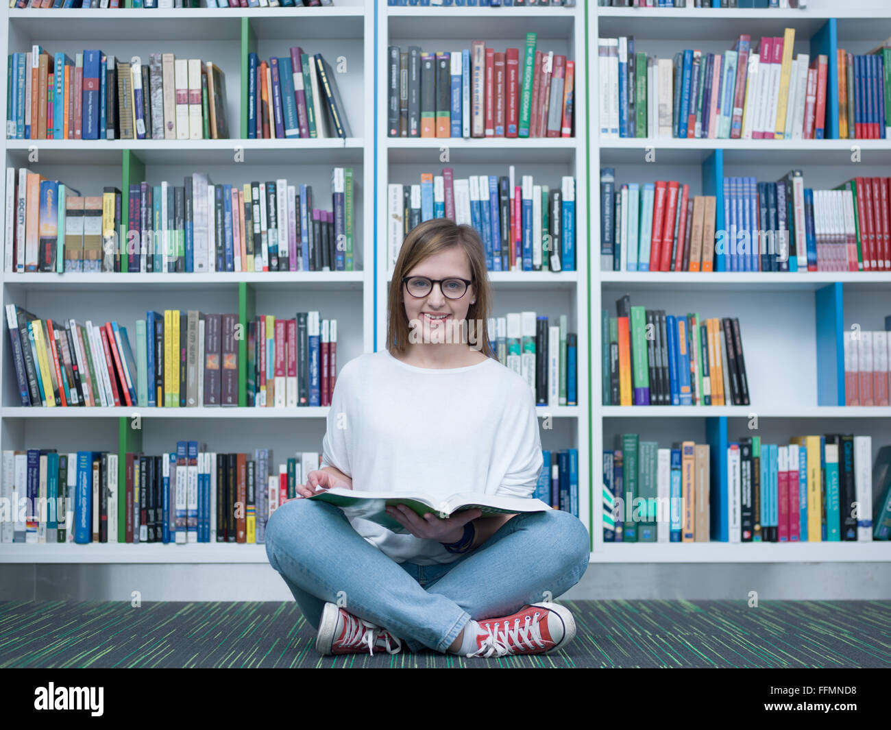 student girl in collage school library reading book Stock Photo - Alamy