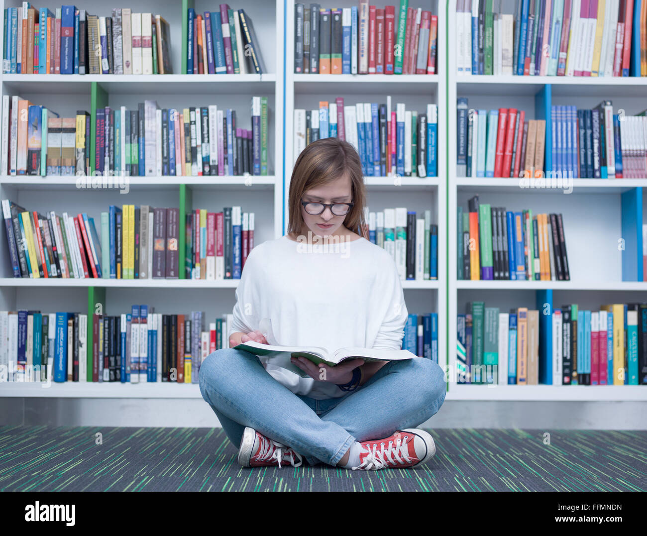 student girl in collage school library reading book Stock Photo - Alamy
