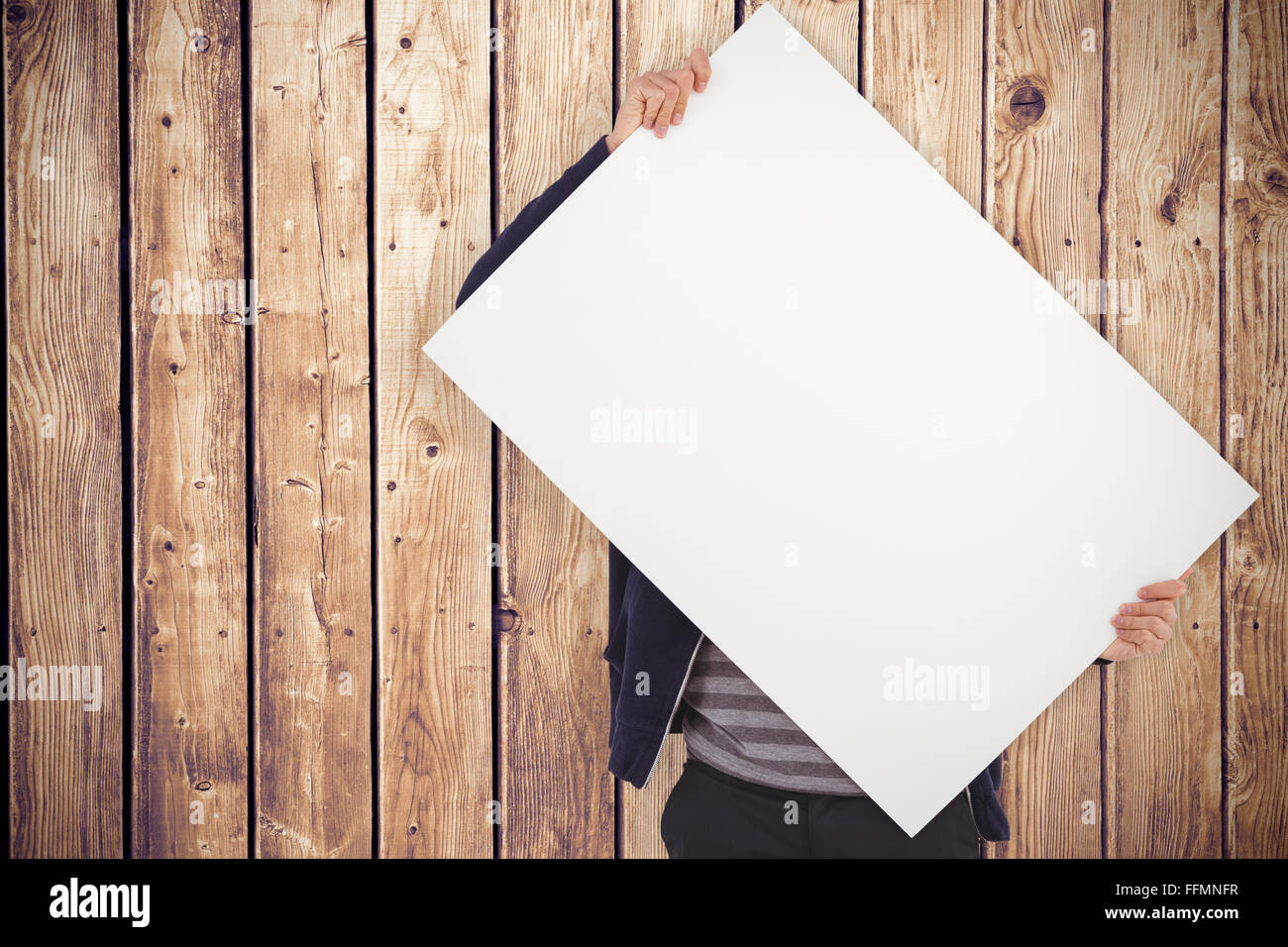 Composite image of man holding billboard in front of face Stock Photo ...