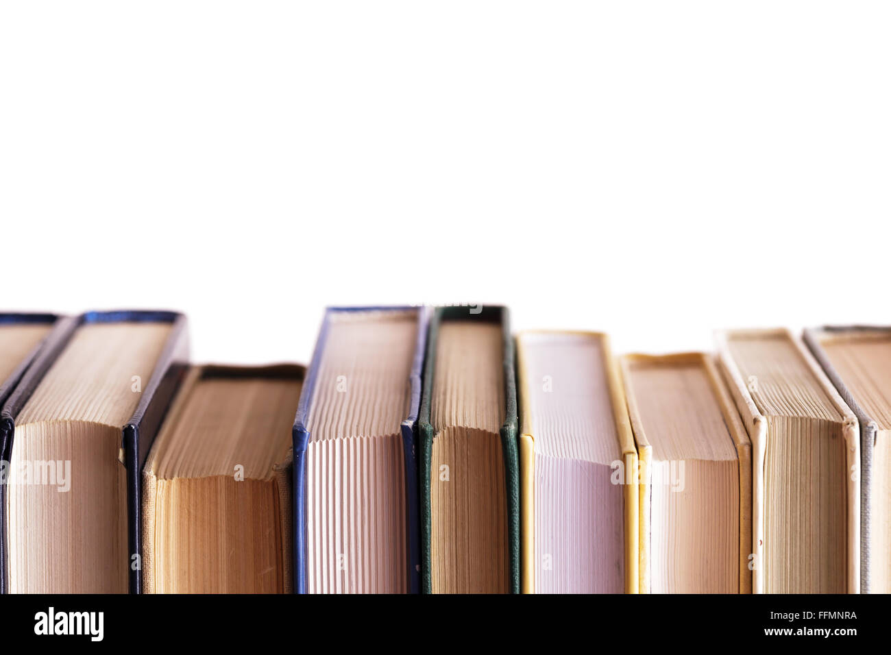 Getting an education: reading books. Stack of books on a white ...