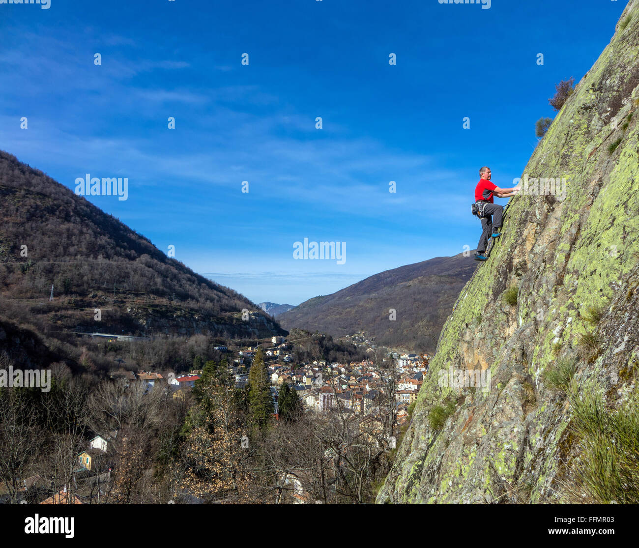 Rock climber in red rock climbing on cliff face Stock Photo - Alamy