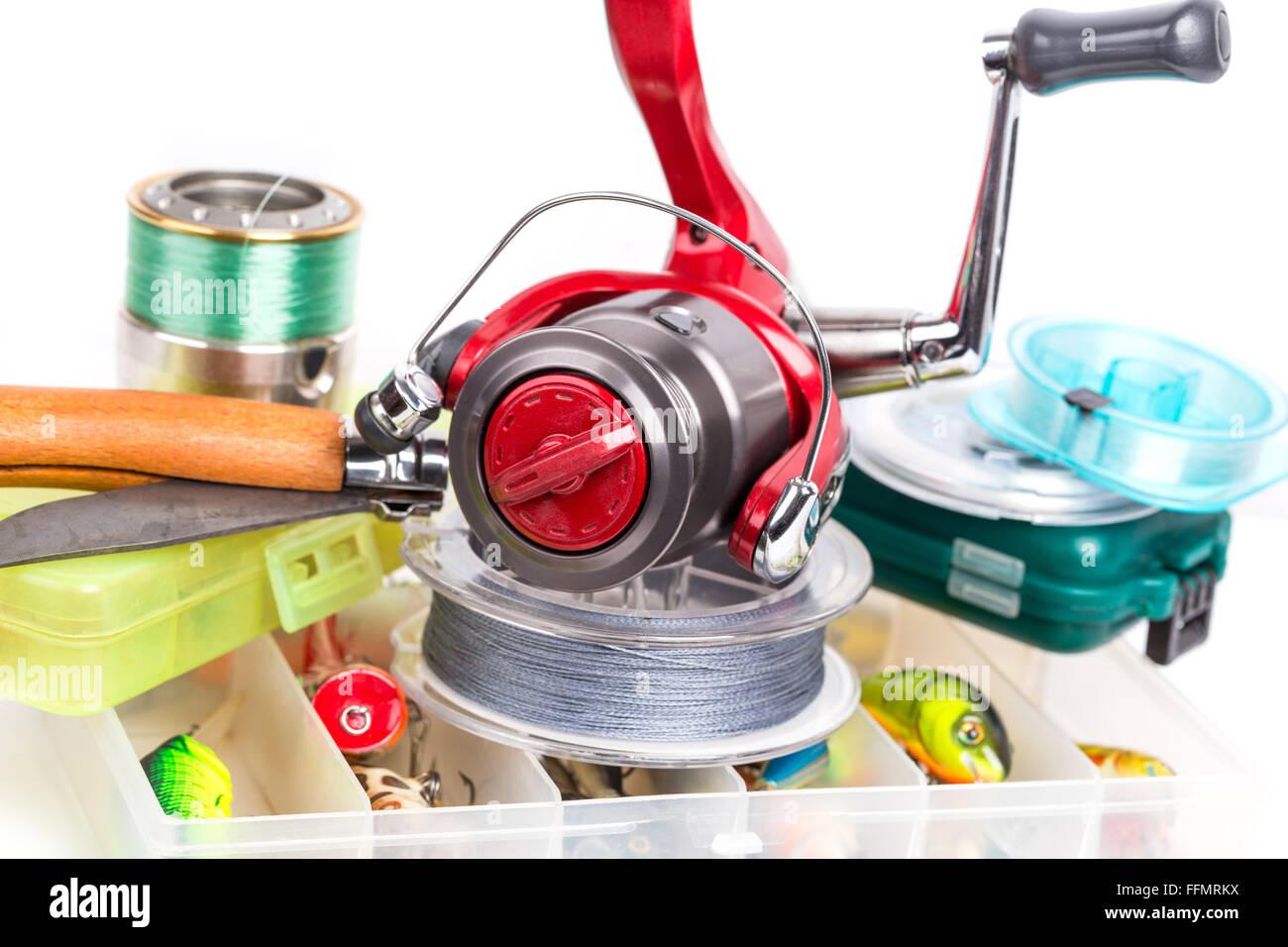 fishing tackles and baits in storage boxes with reel and spool of line ...