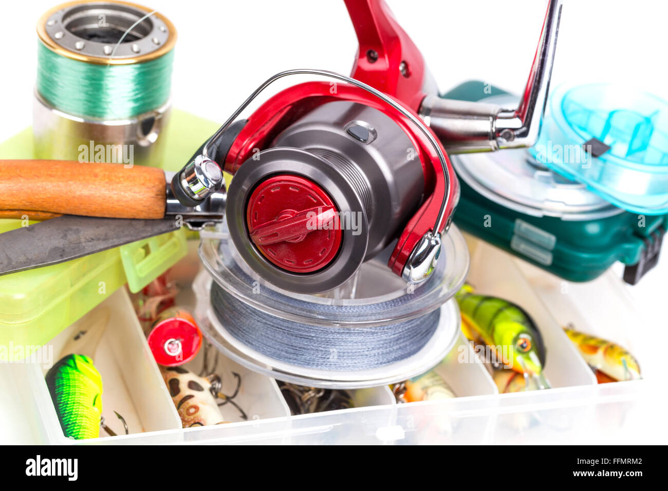 fishing tackles and baits in storage boxes with reel and spool of line ...