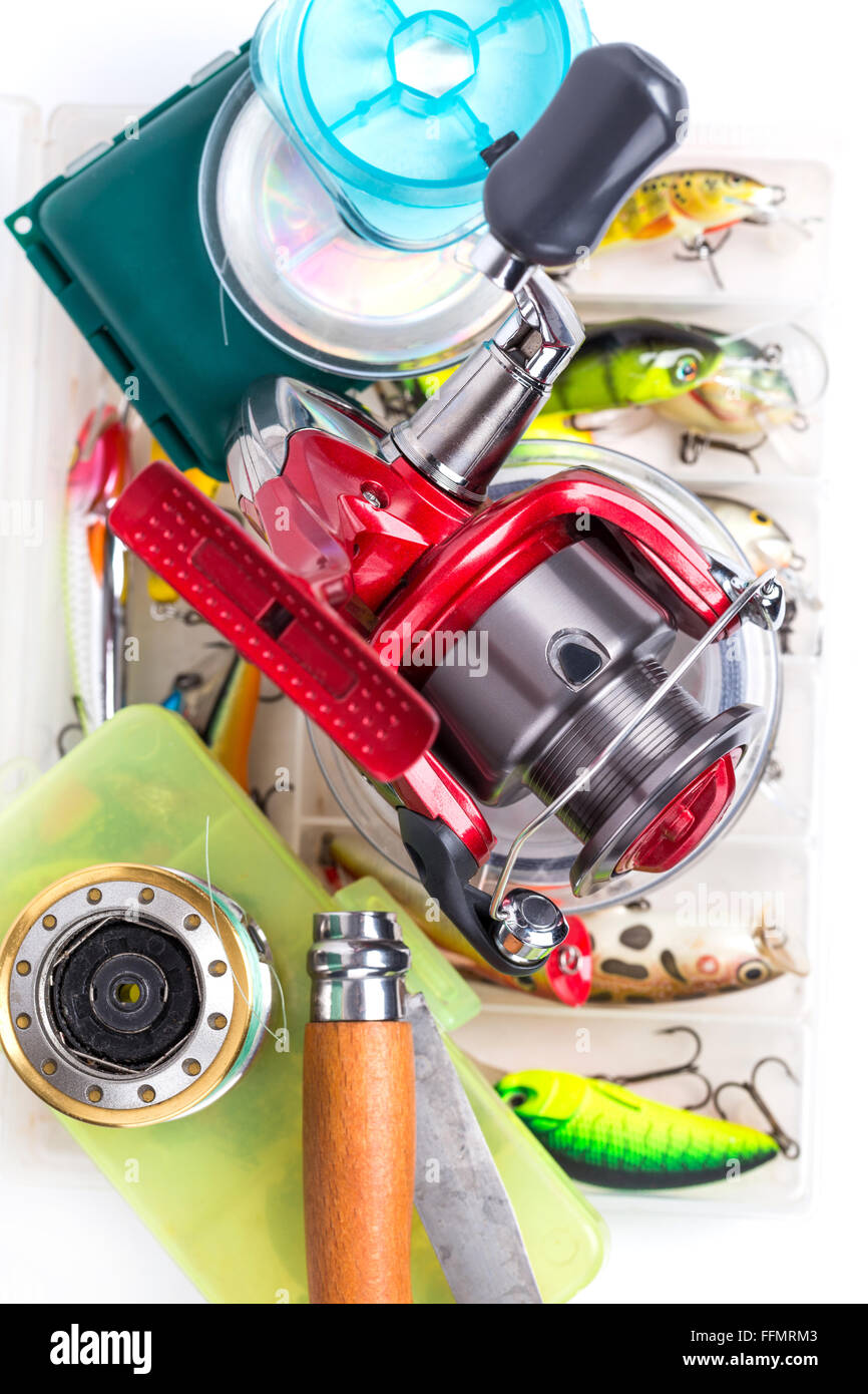 fishing tackles and baits in storage boxes with reel and spool of line ...